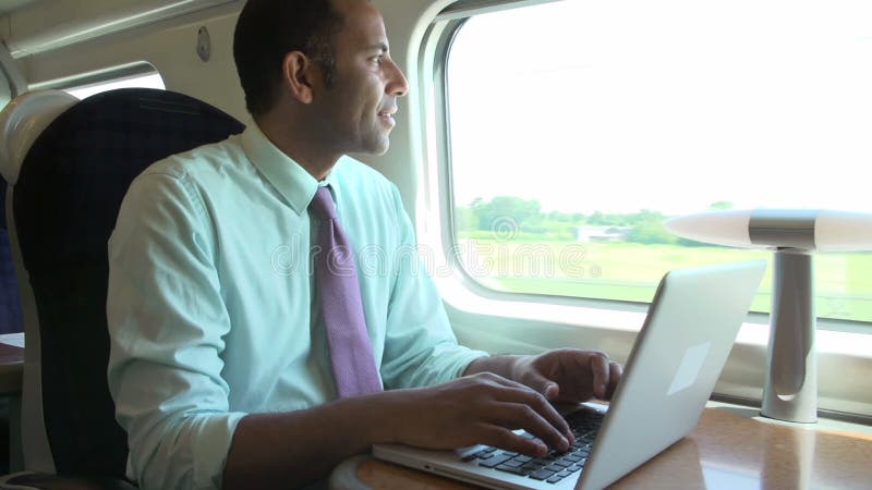 Businessman Commuting To Work on Train and Using Laptop Stock Video ...