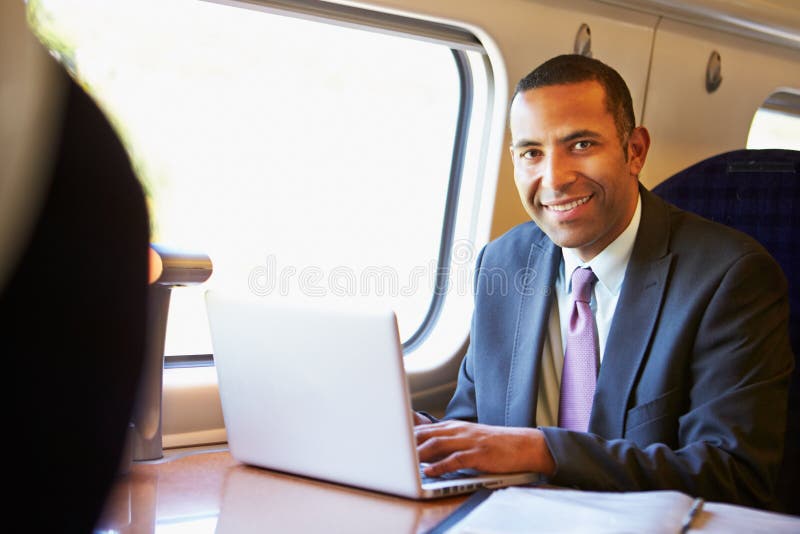 Businessman Commuting To Work on Train and Using Laptop Stock Photo ...