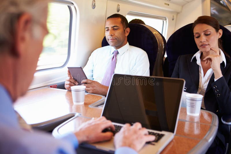 Businessman Commuting To Work on Train and Using Laptop Stock Photo ...