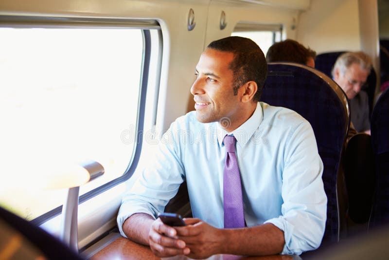 Businessman Commuting To Work on Train and Using Laptop Stock Photo ...