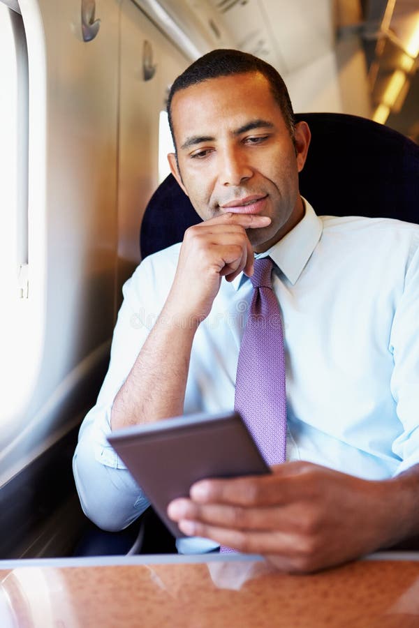Businessman Commuting To Work on Train and Using Laptop Stock Photo ...