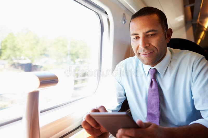 Businessman Commuting To Work on Train and Using Laptop Stock Photo ...