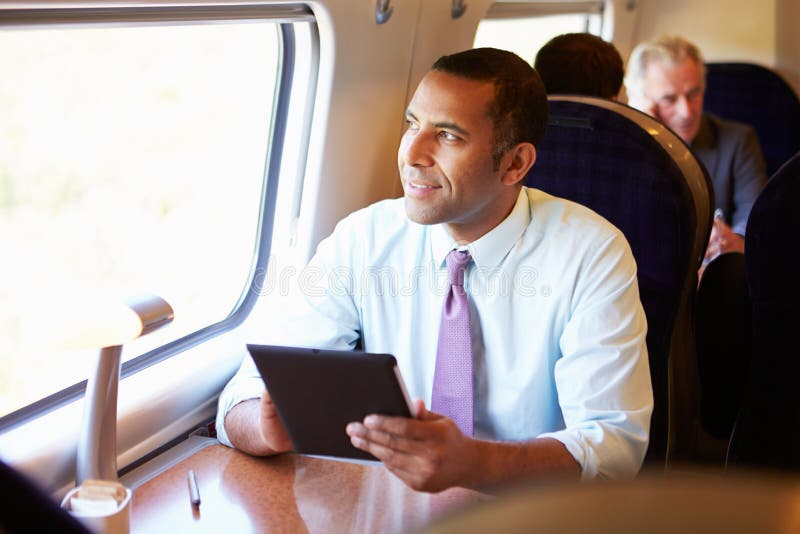 Businessman Commuting on Train Using Digital Tablet Stock Image - Image ...