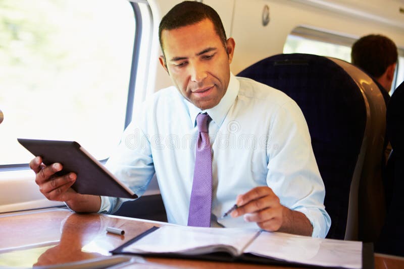 Businessman Commuting To Work on Train and Using Laptop Stock Photo ...