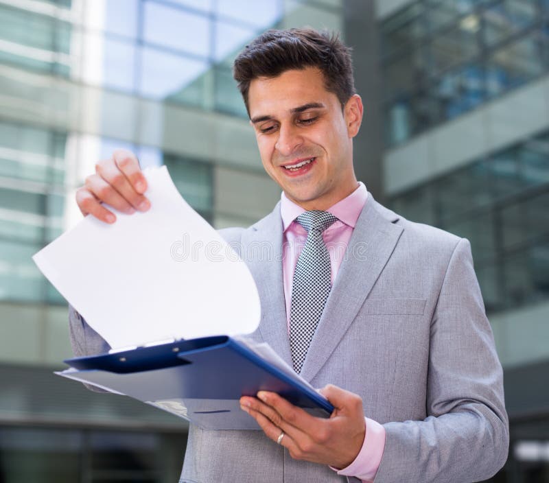 Businessman Contentedly Reading Documents Stock Photo - Image of ...