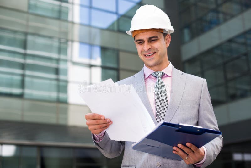 Businessman Contentedly Reading Documents Stock Image - Image of ...