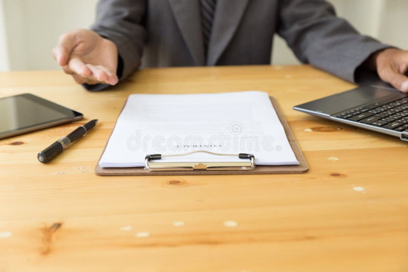 Businessman with a Contract Giving a Hand - Presenting & Signing Stock ...