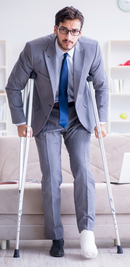Businessman with Crutches and Broken Leg at Home Working Stock Photo ...