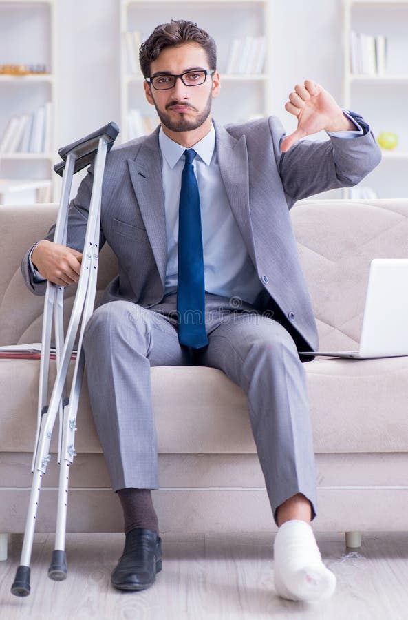 Businessman with Crutches and Broken Leg at Home Working Stock Photo ...