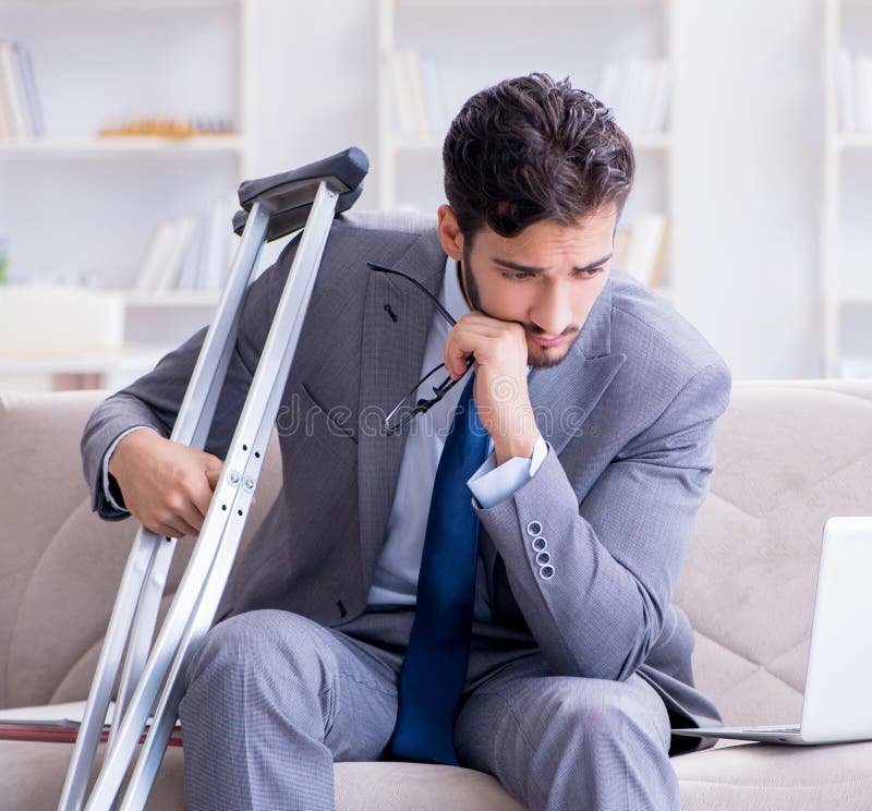 Businessman with Crutches and Broken Leg at Home Working Stock Image ...
