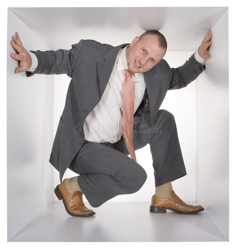Businessman in a Cramped Cardboard Office Trying To Focus on His Work ...