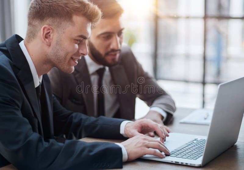 Two Professional Businessmen Discussing and Using Desktop Computer in ...