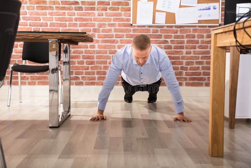 Businessman Doing Push Up in Office Stock Photo - Image of modern ...