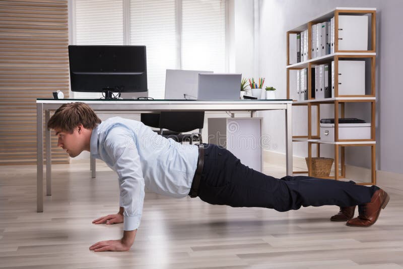 Businessman Doing Push Up in Office Stock Photo - Image of people ...