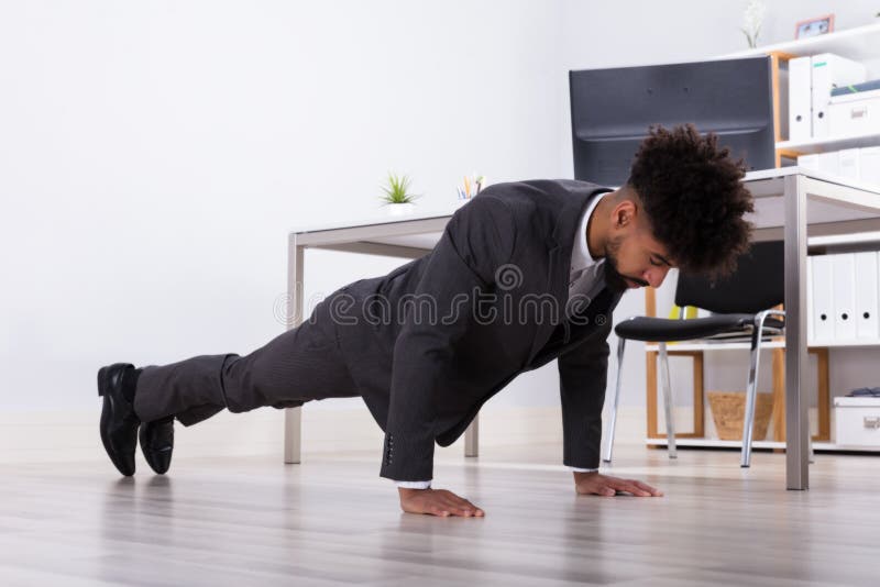 Businessman Doing Push Up in Office Stock Photo - Image of professional ...
