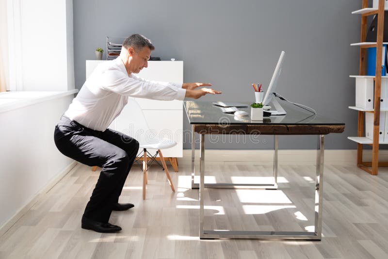 Businessman Doing Squats Exercise in Office Stock Image - Image of ...