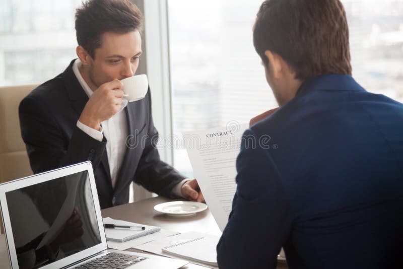 The Partner Examining or Analyzing Resume Documents on Desk at the ... The Partner Examining or Analyzing Resume Documents on Desk at the ...