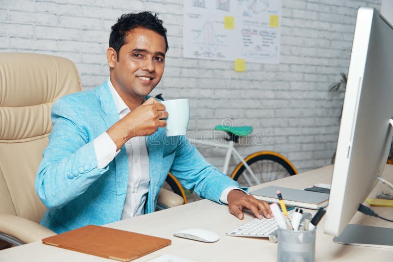 Businessman Drinking Coffee at Workplace at Office Stock Photo - Image ...