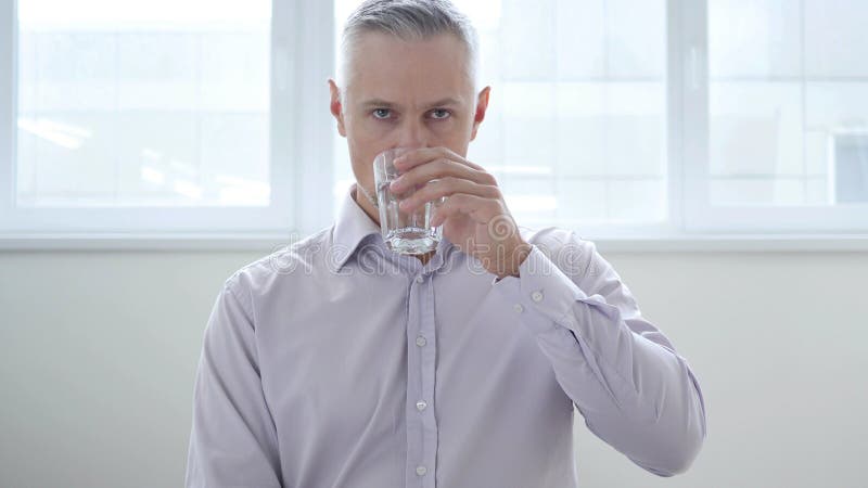 Businessman Drinking Water in Office Stock Photo - Image of casual ...