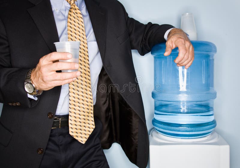 Business People Interacting at a Water Cooler Stock Image - Image of ...