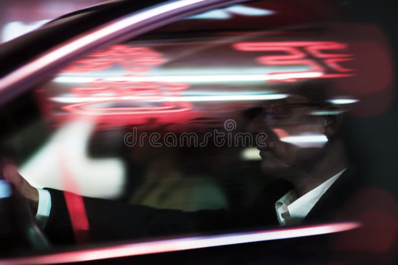 Businessman Driving at Night, Illuminated and Reflected Lights on the ...