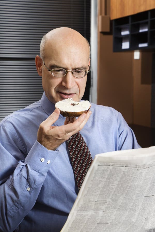 Businessman eating bagel stock photo. Image of paper, bagel - 2046902