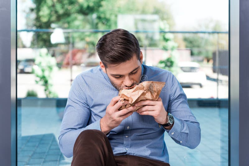 Businessman Eating Hamburger while Sitting Stock Photo - Image of ... Businessman Eating Hamburger while Sitting Stock Photo - Image of ...