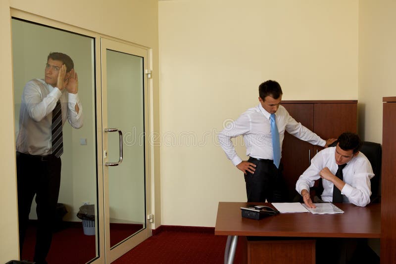Businessman Eavesdropping on Conversation between Colleagues in Office ...