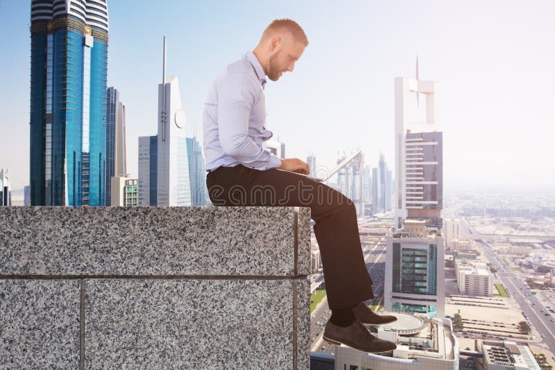 Businessman on the Edge of Roof Using Laptop Stock Image - Image of ...