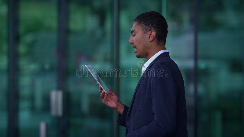 A Businessman Engaged with a Tablet in a Modern Office Infrastructure ...