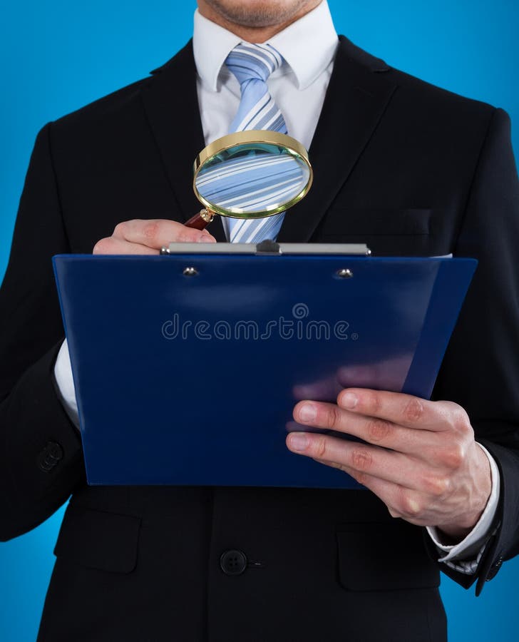 Businessman Examining Invoice with Magnifying Glass Stock Photo - Image ...