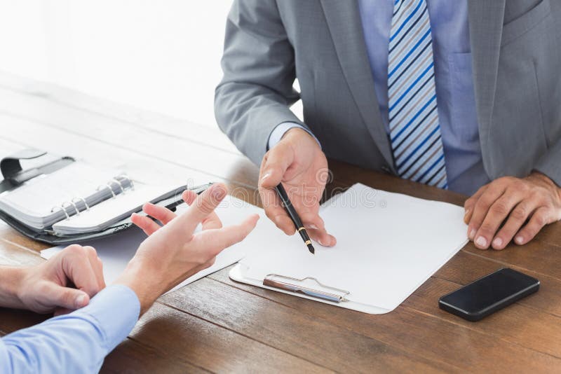 Businessman Explaining Contract To Co Worker Stock Image - Image of ...
