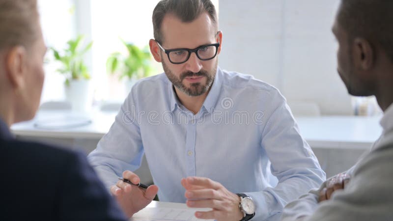 Businessman Explaining Documents To Colleagues Stock Image - Image of ...