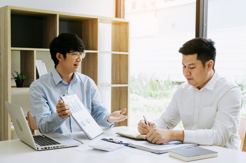 Businessman Explaining Financial Budget Figures in Report Paper To ...