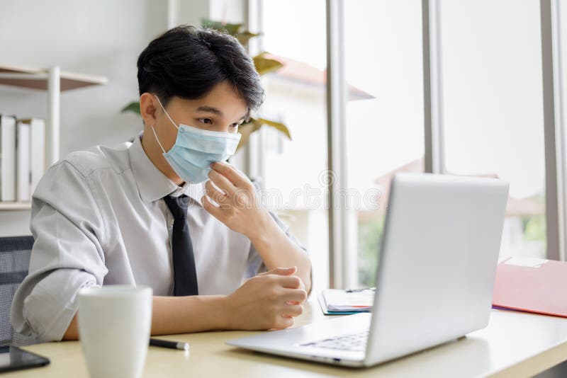 Businessman with Face Mask Using Laptop Computer at Work in Office ...