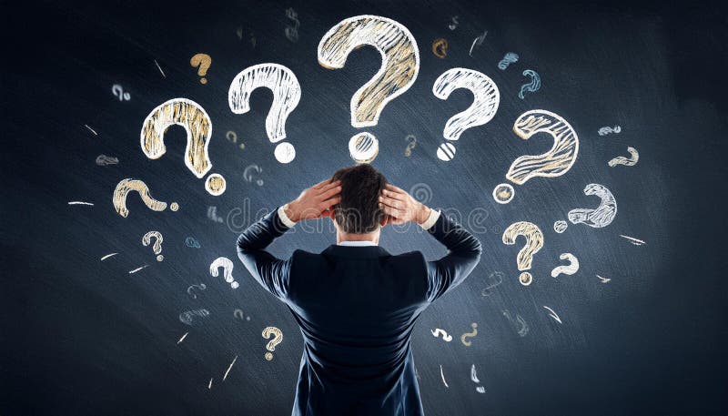 Businessman Facing Chalkboard with Multiple Question Marks on a Dark ...