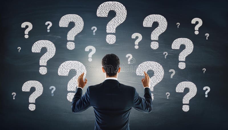 Businessman Facing Chalkboard with Multiple Question Marks on a Dark ...