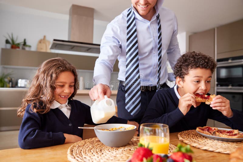 Businessman Father in Kitchen Helping Children with Breakfast before ...