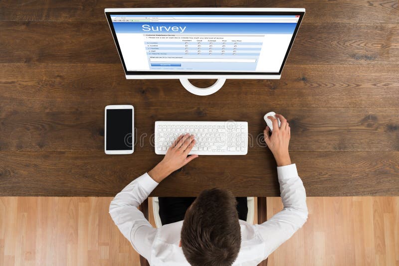 Businessman Filling Survey Form on Computer Stock Photo - Image of ...