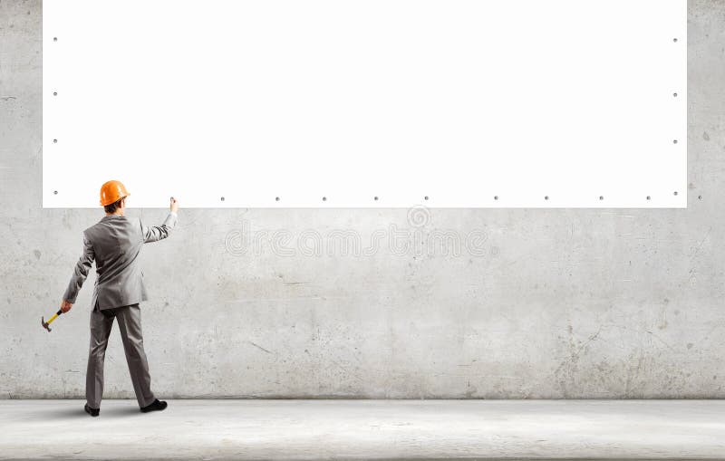 Businessman fixing banner stock photo. Image of business - 47531626