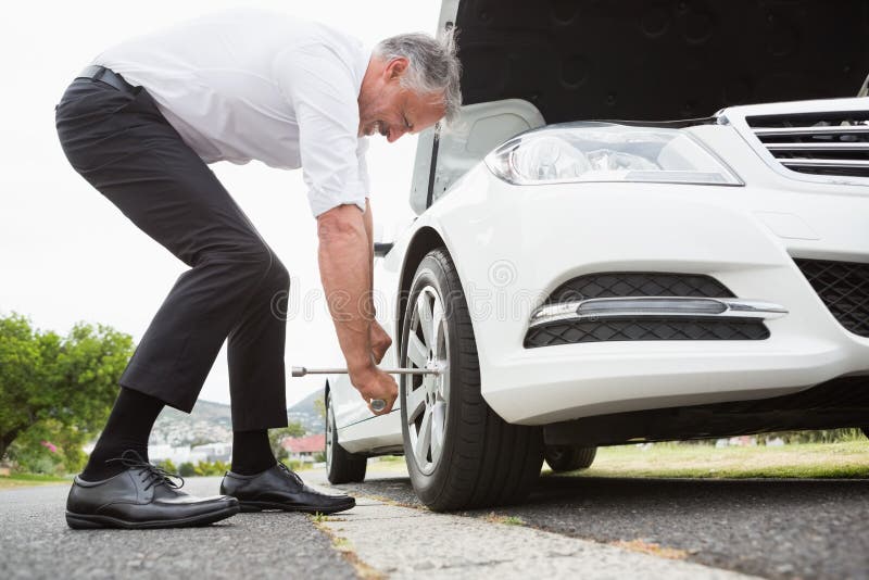 Businessman fixing tire stock image. Image of hubcap - 50489945