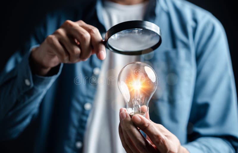 Businessman Focus with Magnifying To Light Bulb with Business Target ...