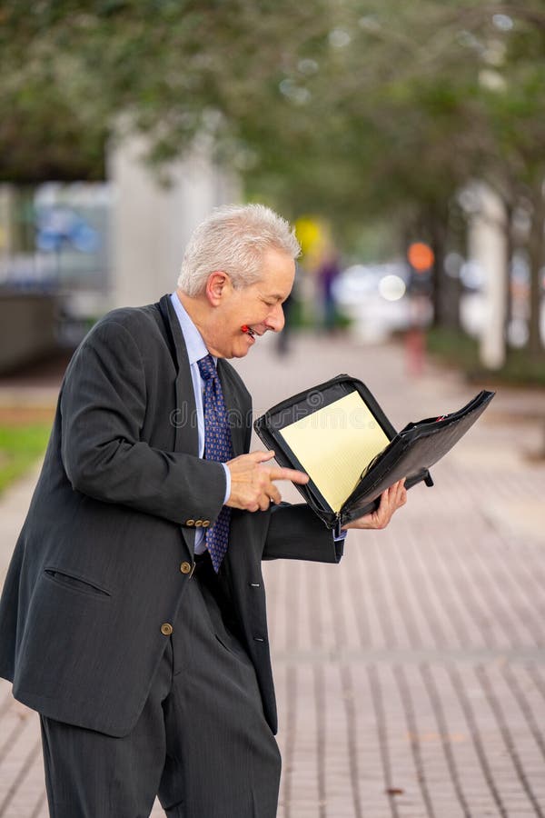 Businessman Fumbling through His Notebook Stock Image - Image of middle ...