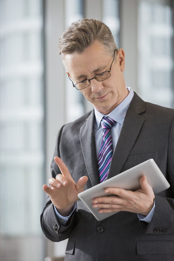 Businessman Gesturing while Using Digital Tablet in Office Stock Photo ...