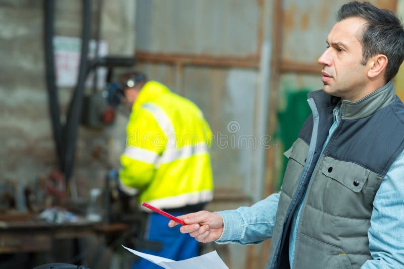 Businessman Giving Directions at Warehouse Stock Image - Image of ...