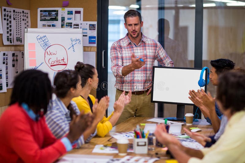 Businessman Giving Presentation To Colleagues in Office Stock Image ...