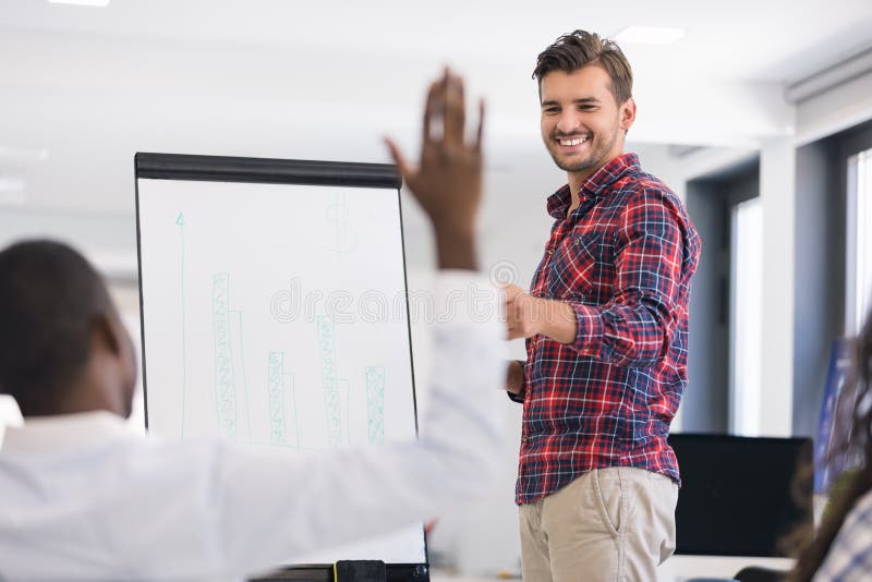 Businessman Giving a Presentation To His Colleagues at Work Stock Image ...