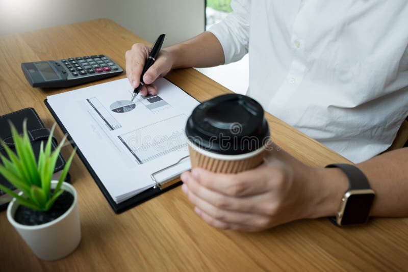 Businessman Going through Some Paperwork and Signing a Document Stock ...