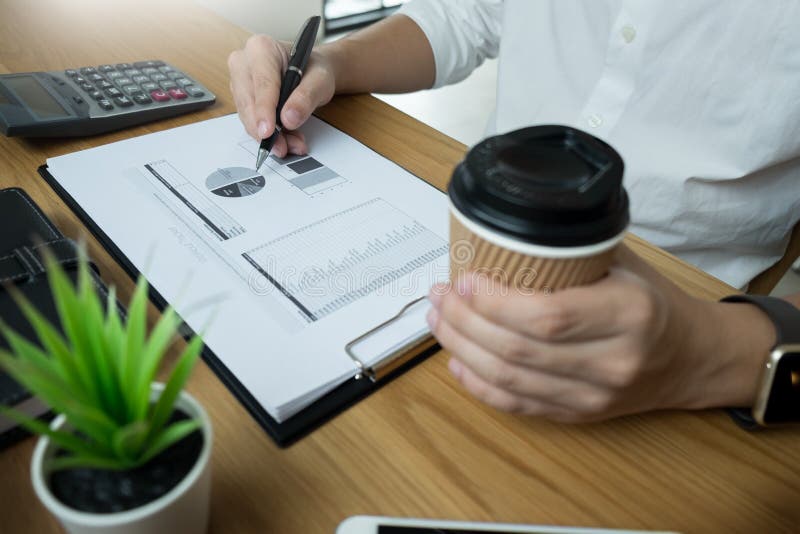 Businessman Going through Some Paperwork and Signing a Document Stock ...