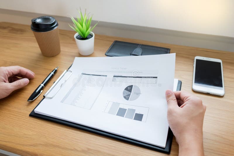 Businessman Going through Some Paperwork and Signing a Document Stock ...